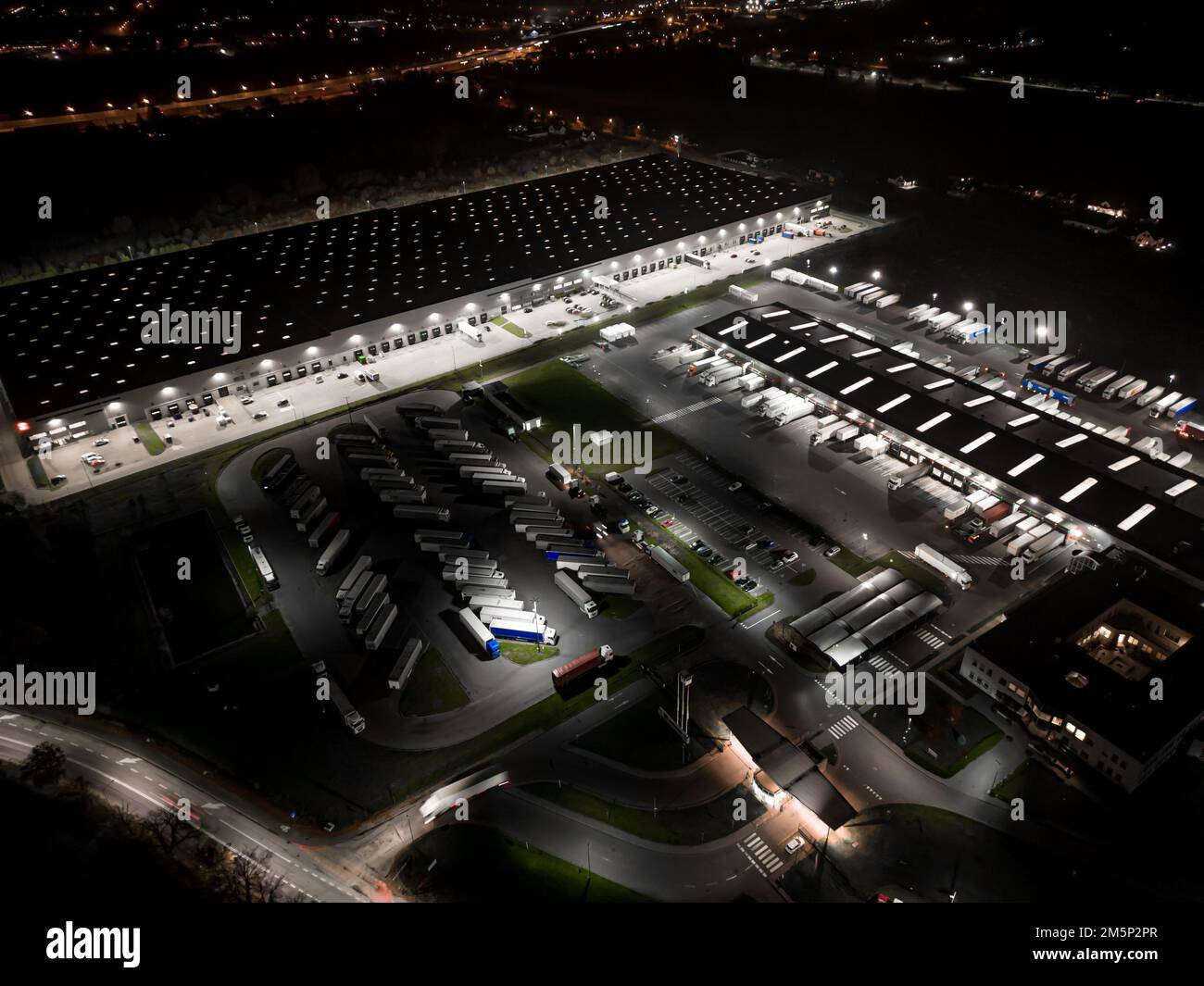 Night aerial view of a warehouse of goods for online stores. Logistic ...