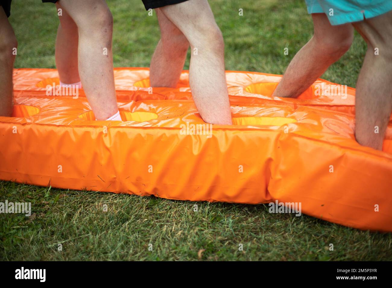 Race walking. Team play. Orange inventory for games. Men in shorts go ...