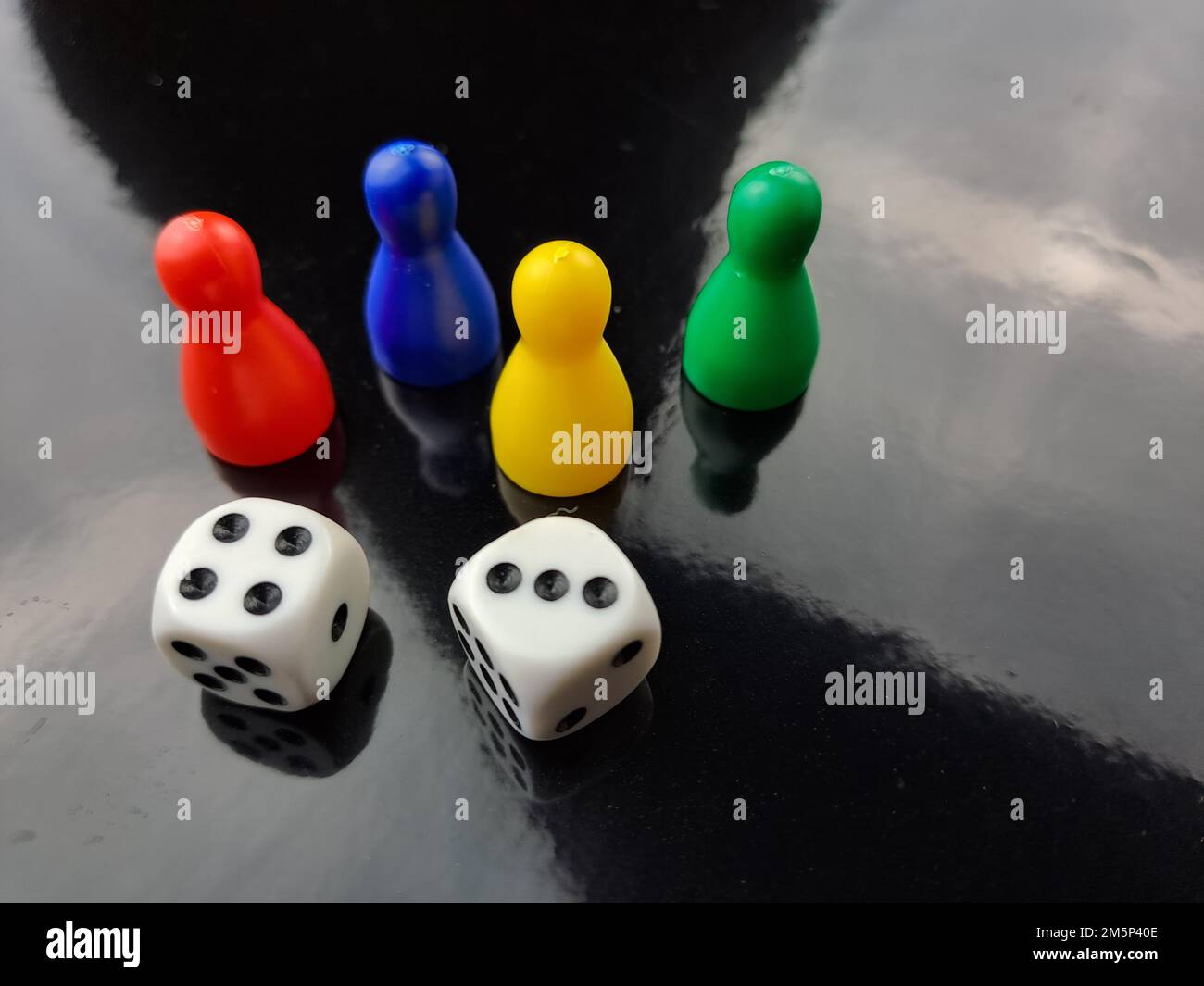 Board Game Pawns And Dice With Colored Pieces Stock Photo - Alamy