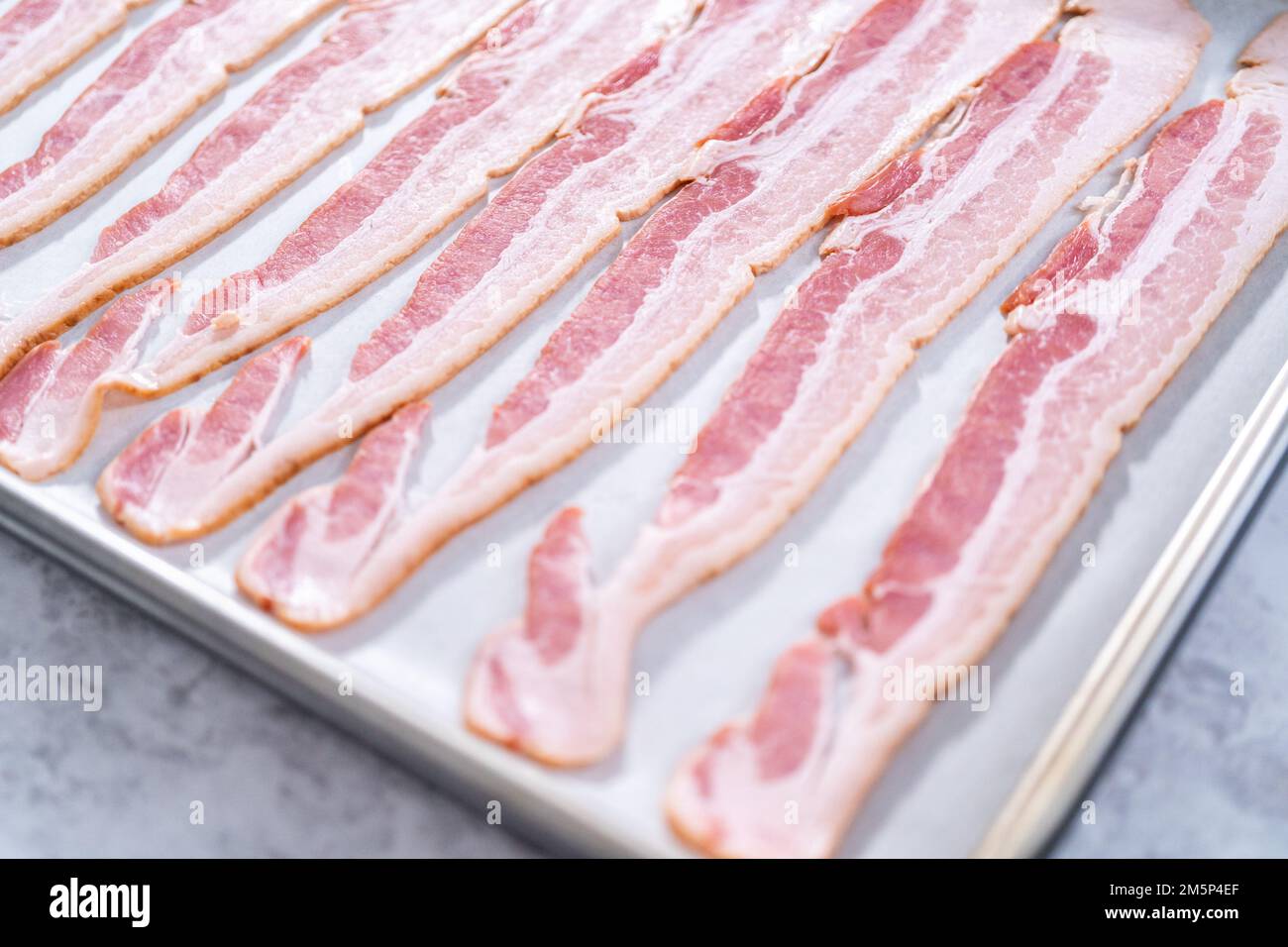 Cooking bacon strips Stock Photo - Alamy