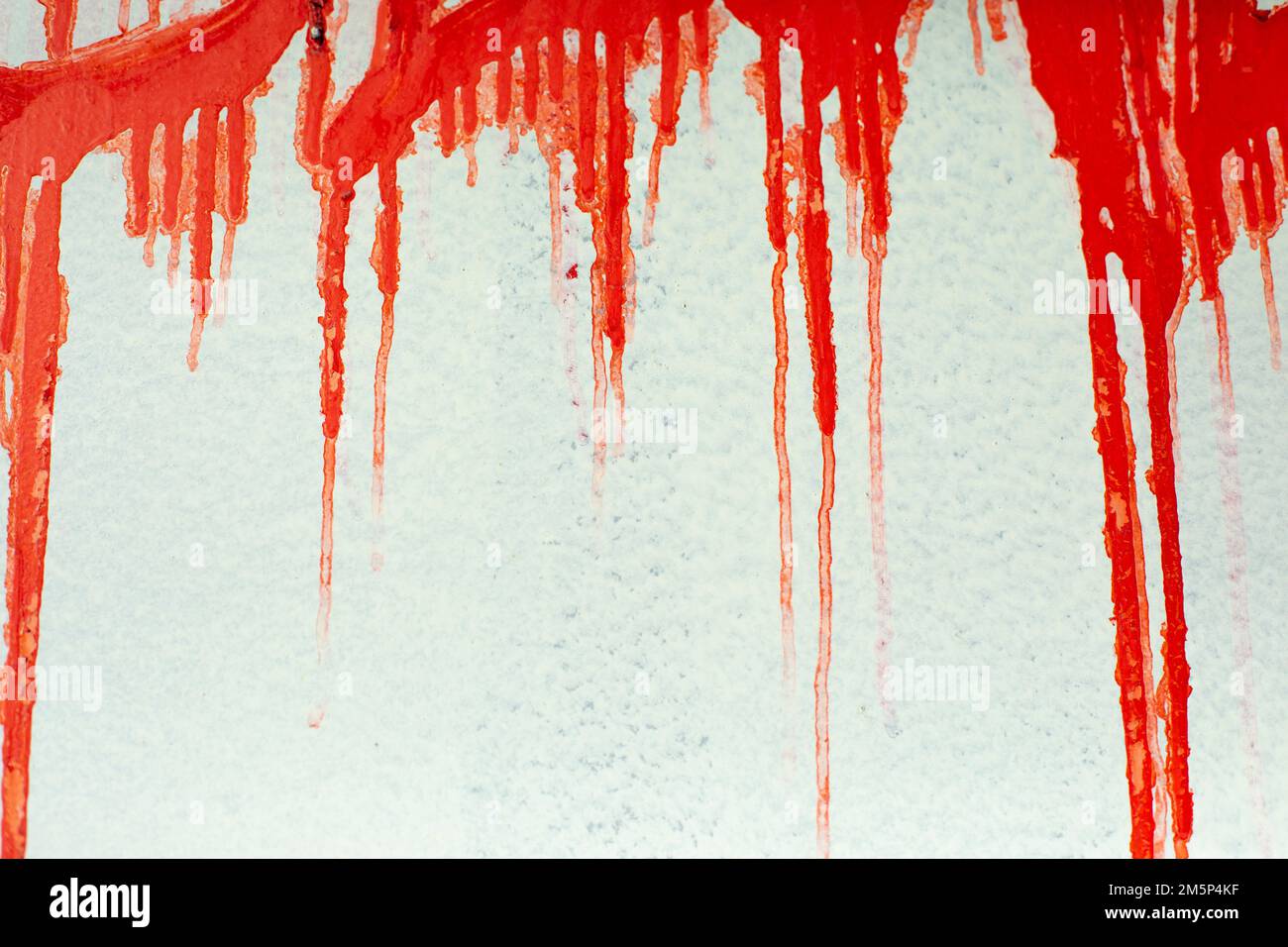Red paint flows across white wall. Blood runs down surface. Graffiti ...