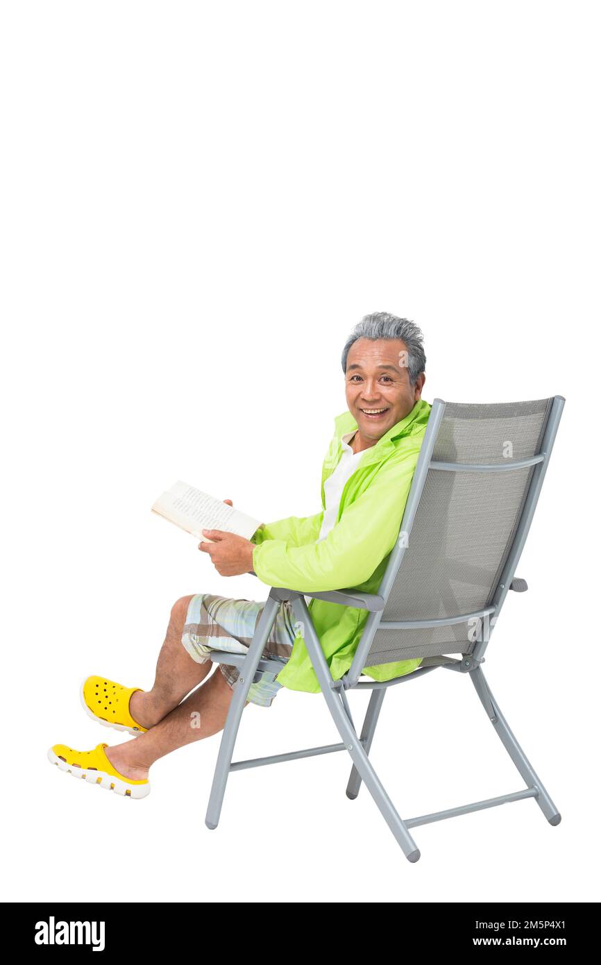 Old man sitting on a beach chair Stock Photo - Alamy