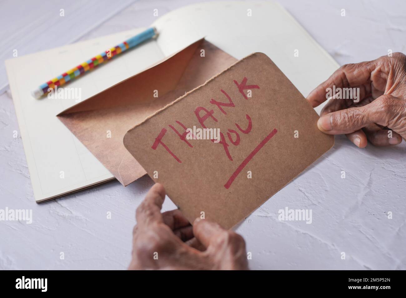 senior women's hand holding thank you letter , rear view Stock Photo ...