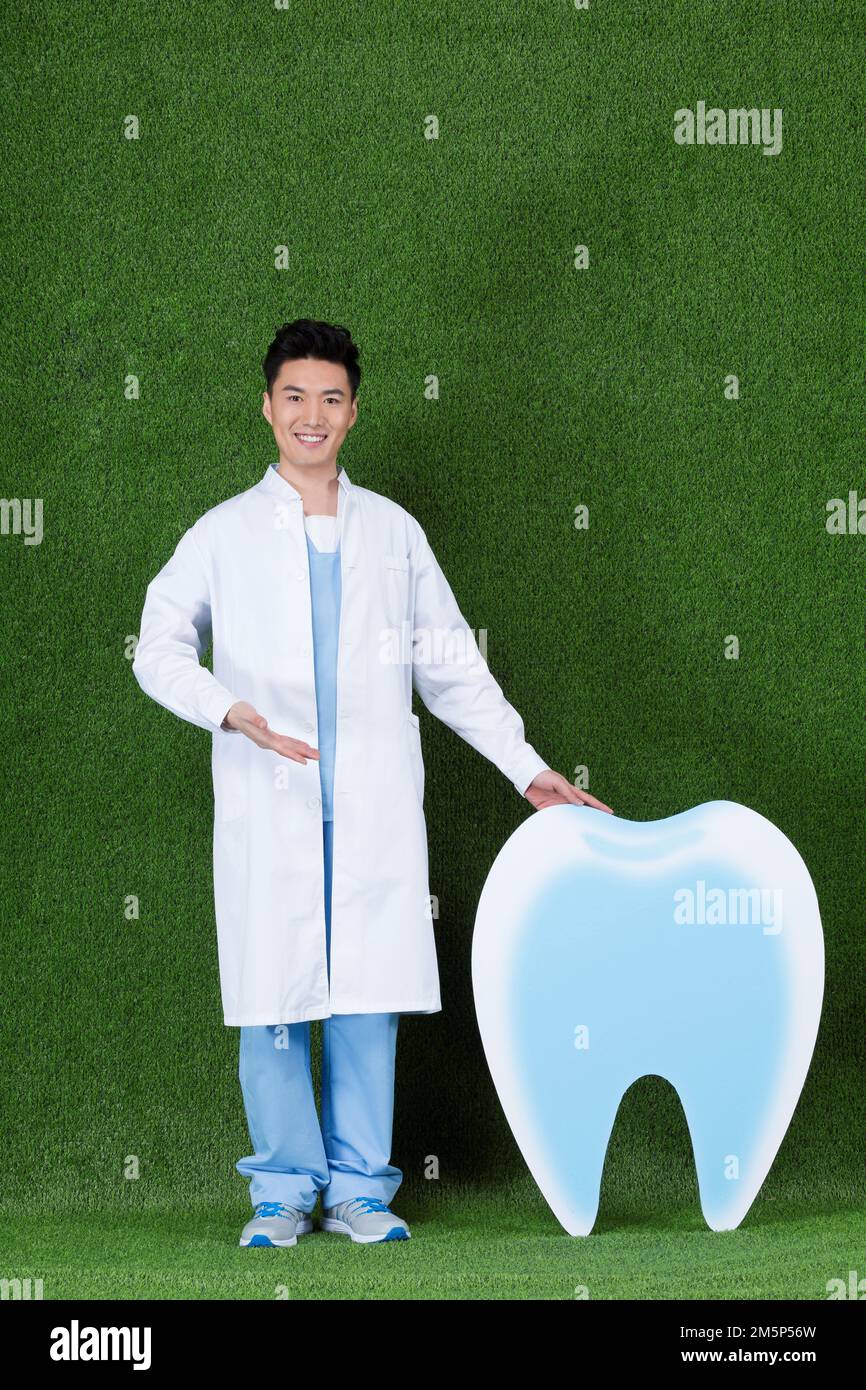 The grass young male dentist Stock Photo - Alamy