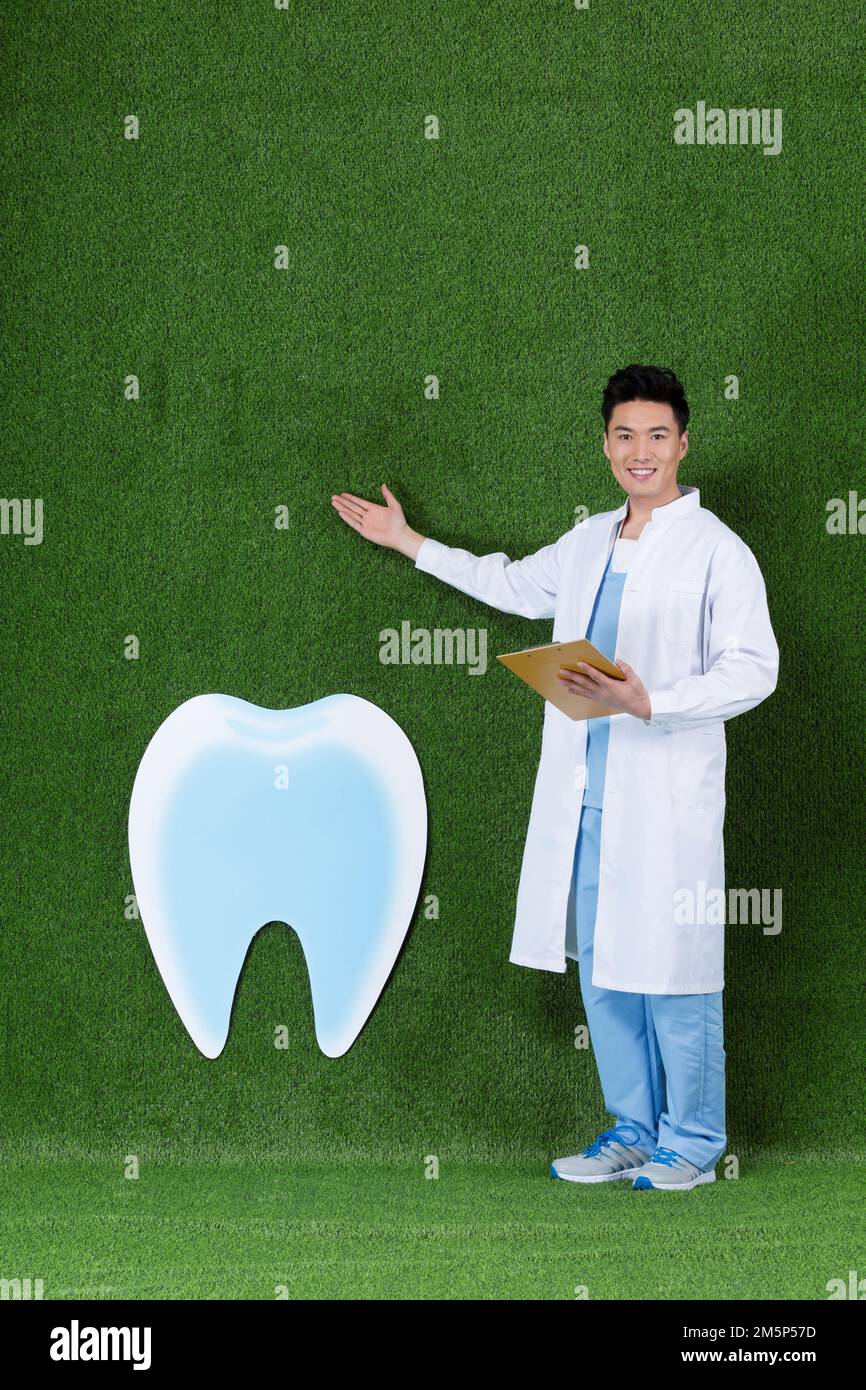 The grass young male dentist Stock Photo - Alamy