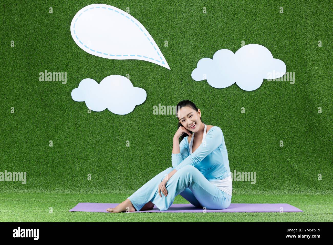 The grass creative women yoga Stock Photo - Alamy