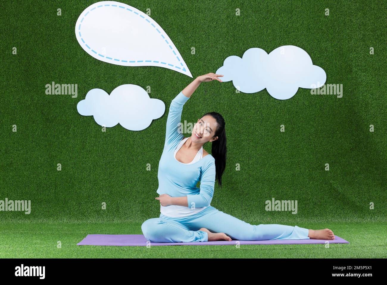 The grass creative women yoga Stock Photo - Alamy