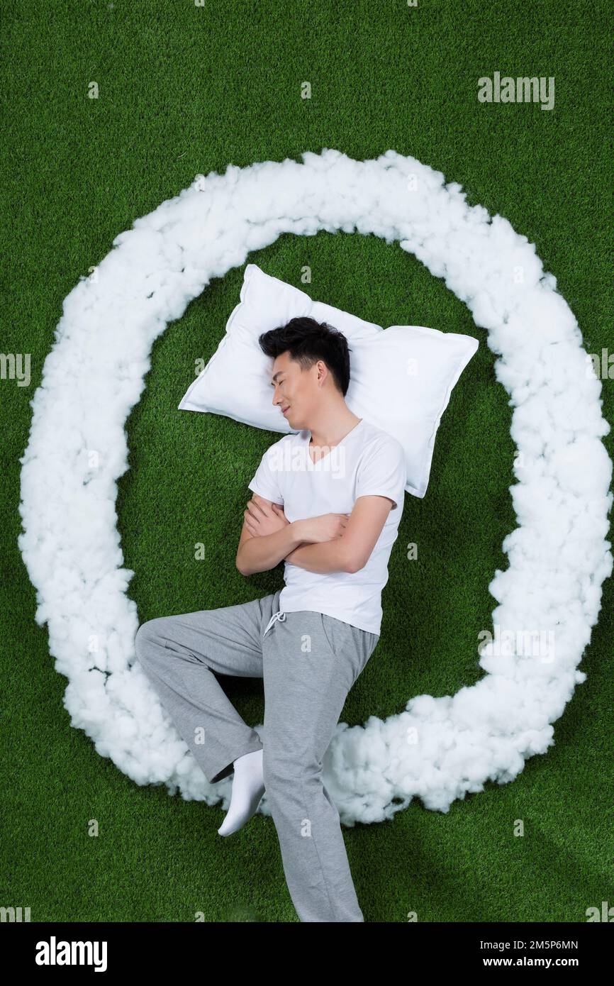 The grass sleep creative young men Stock Photo - Alamy
