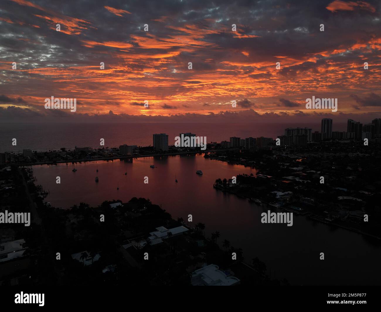 Aerial view of sunrise over a lake and the ocean Stock Photo - Alamy
