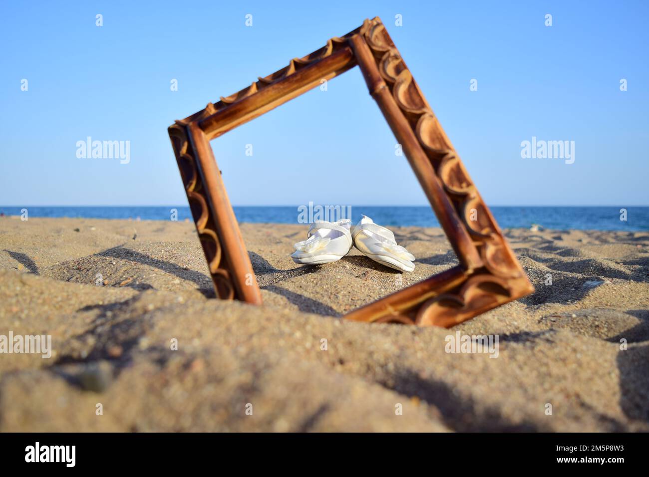A pair of baby shoes in a photo frame, baby shower Stock Photo - Alamy