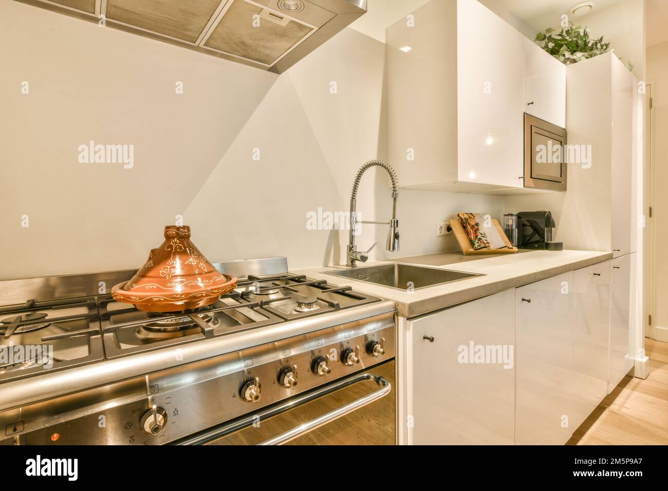 a kitchen with an oven, sink and dishwasher in the photo is taken from ...