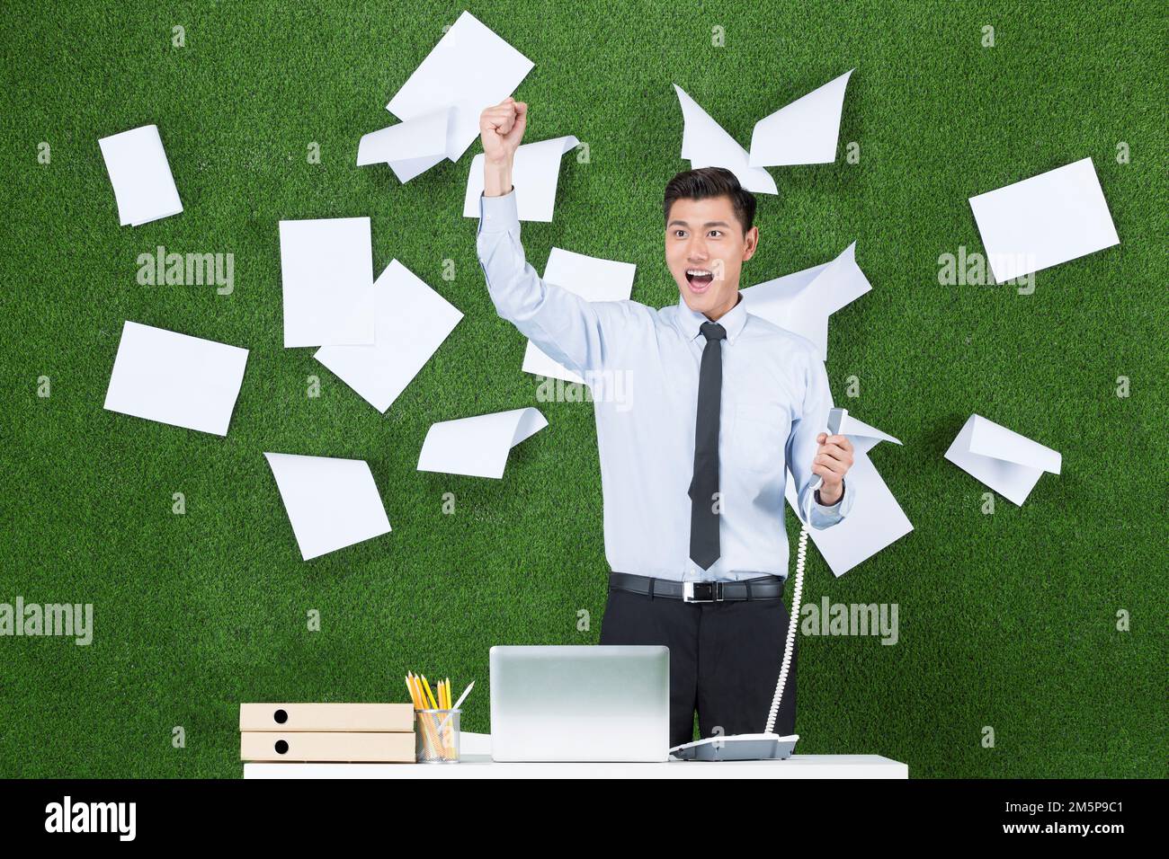 The grass business men throw paper into the air Stock Photo - Alamy