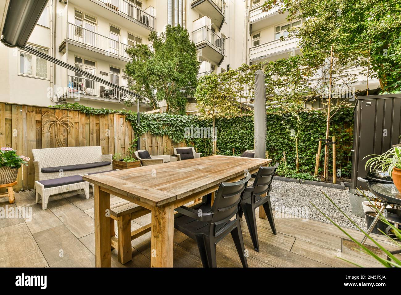an outdoor patio area with furniture and plants in the back yard ...