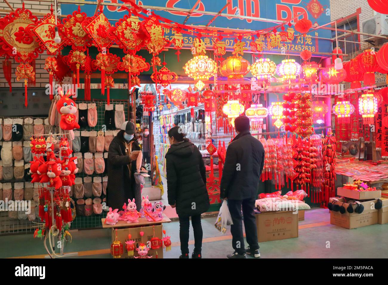 YICHANG, CHINA - DECEMBER 30, 2022 - People buy couplets, lanterns and ...