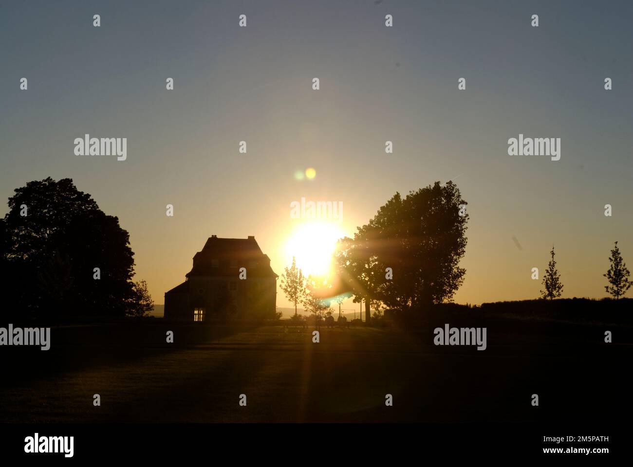 Beautiful sunsets over land and civilization Stock Photo - Alamy