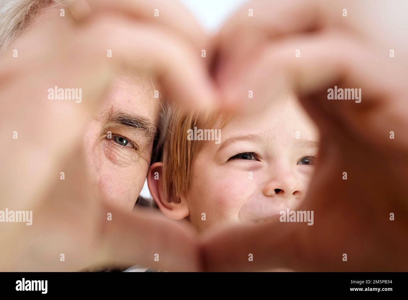 Grandfather and Grandson Making a Heart Shape Hand Gesture Together ...
