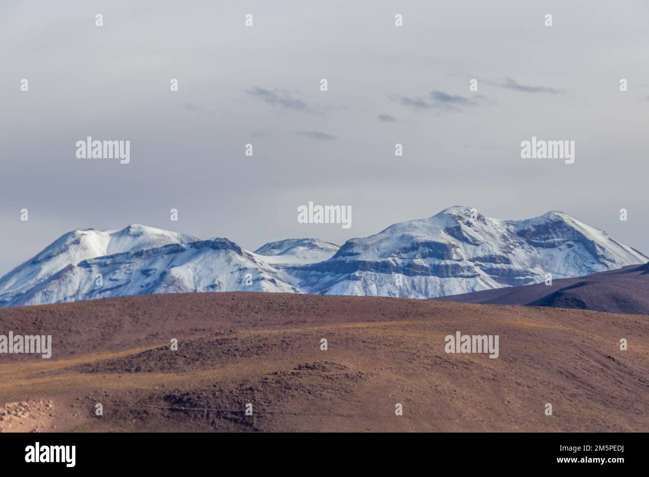 Snow covering the peaks of mountains in Atacama, the driest desert of ...