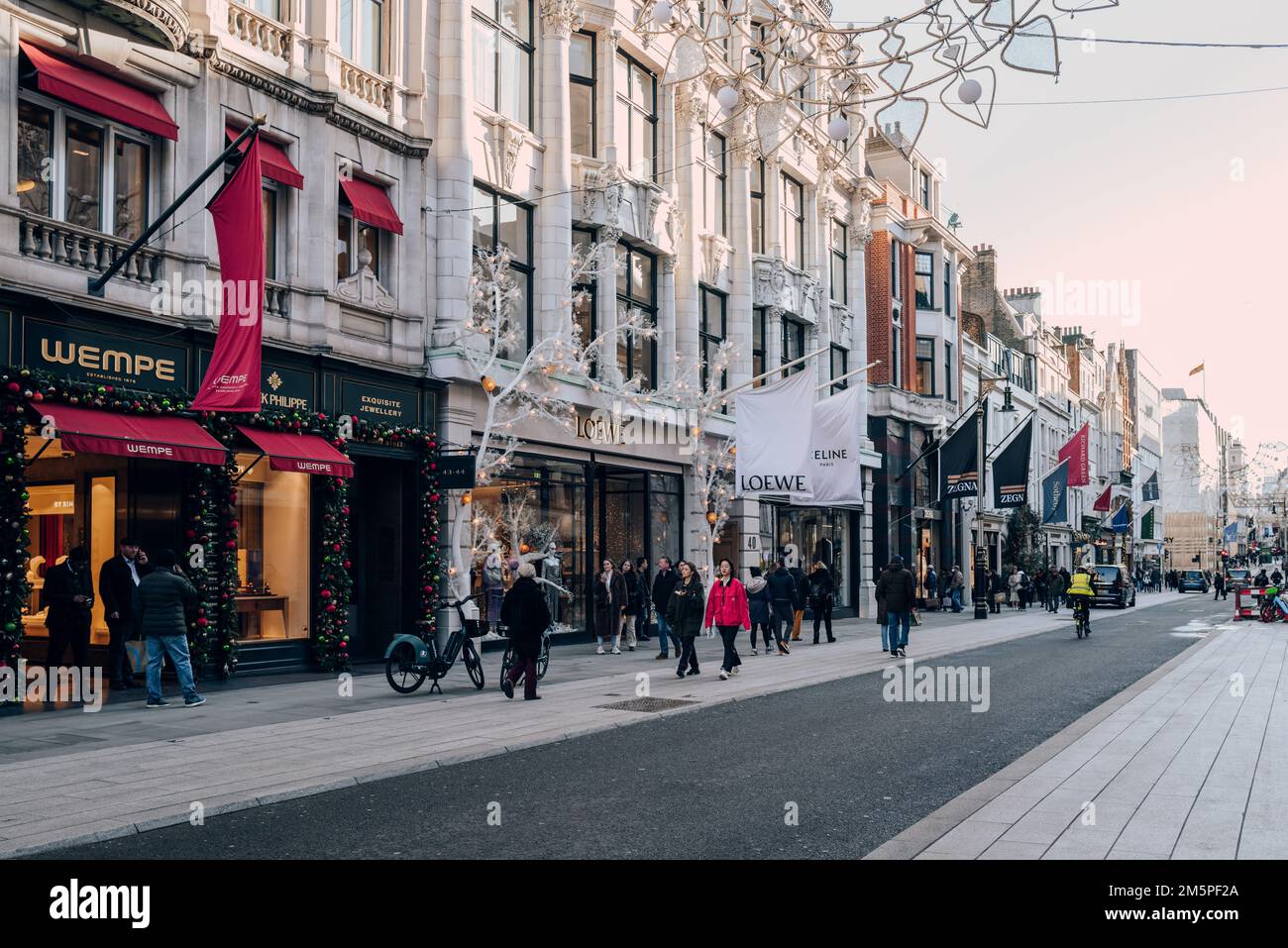 London, UK - December 26, 2022: People walking past the high end stores ...