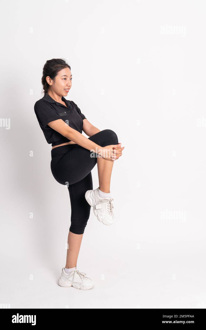 looks full body of woman standing stretching legs Stock Photo - Alamy