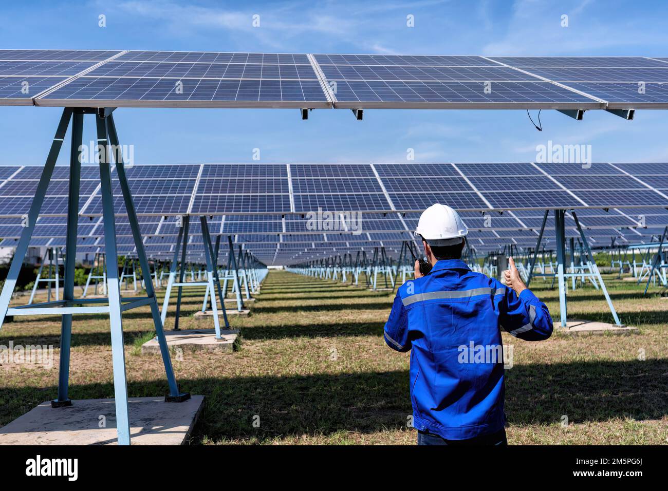 Maintenance engineer at solar farm produce clean electricity walking ...