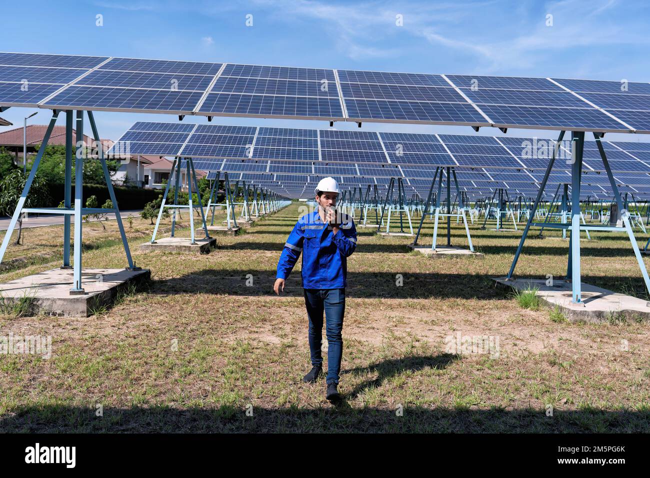 Maintenance engineer at solar farm produce clean electricity walking ...