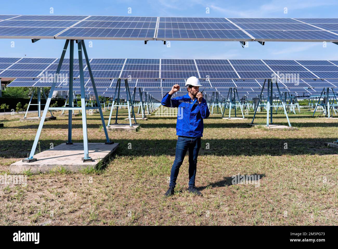 Maintenance engineer at solar farm produce clean electricity walking ...