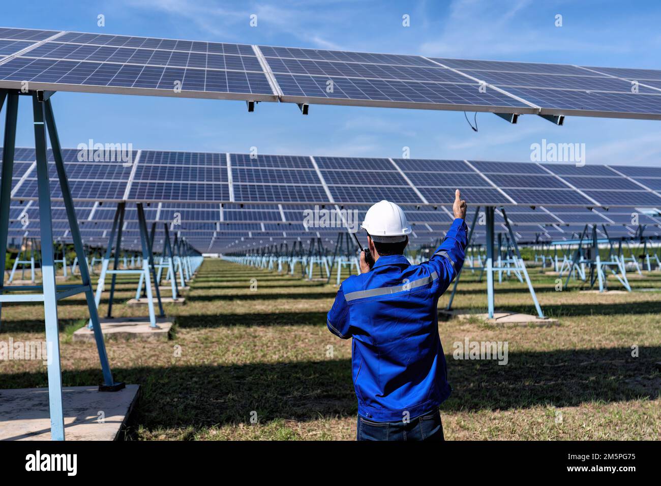 Maintenance engineer at solar farm produce clean electricity walking ...