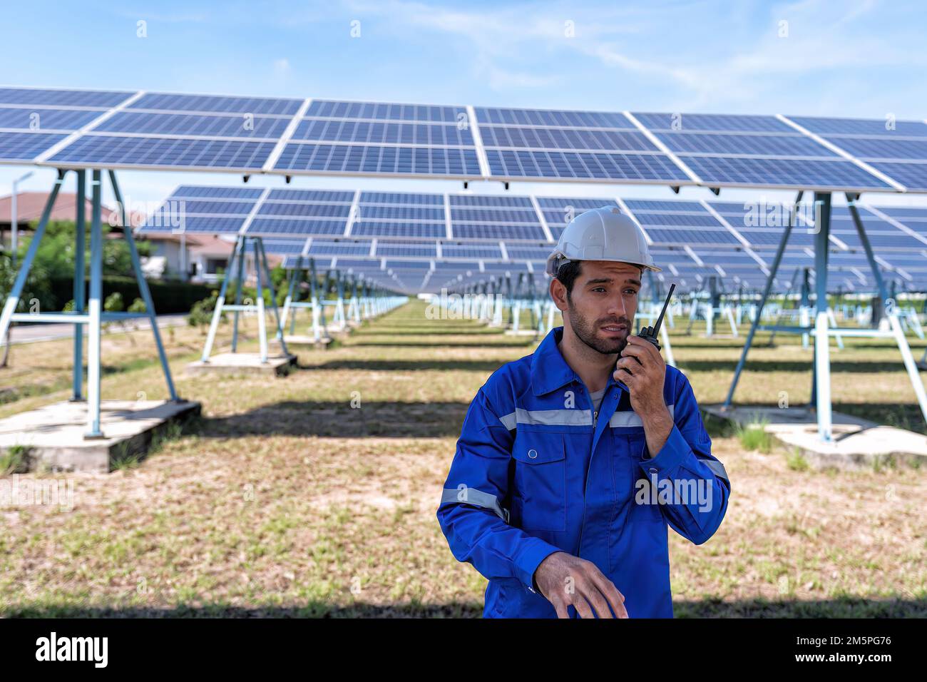 Maintenance engineer at solar farm produce clean electricity walking ...