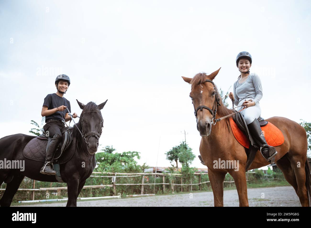 two asian equestrian athletes riding their respective horses Stock ...
