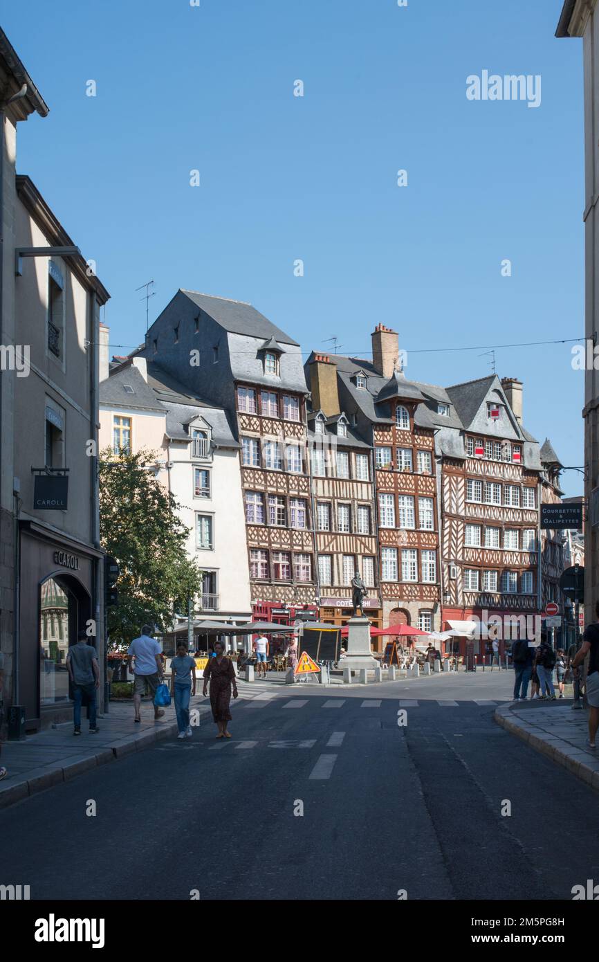 The people walking in a street in Rennes, France against the old style ...