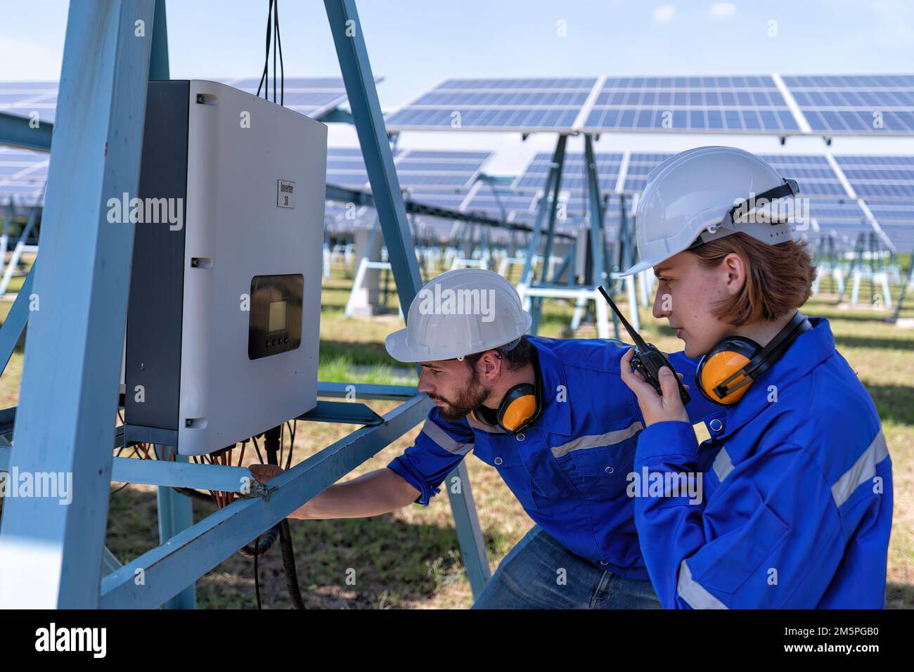 Maintenance engineer at solar farm trouble shooting looking at inverter ...