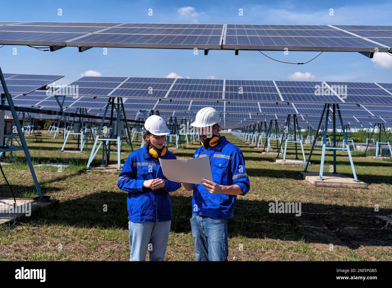 Maintenance engineer at solar farm looking drawing discuss on expansion ...
