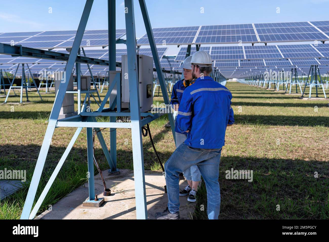 Maintenance engineer at solar farm trouble shooting looking at inverter ...