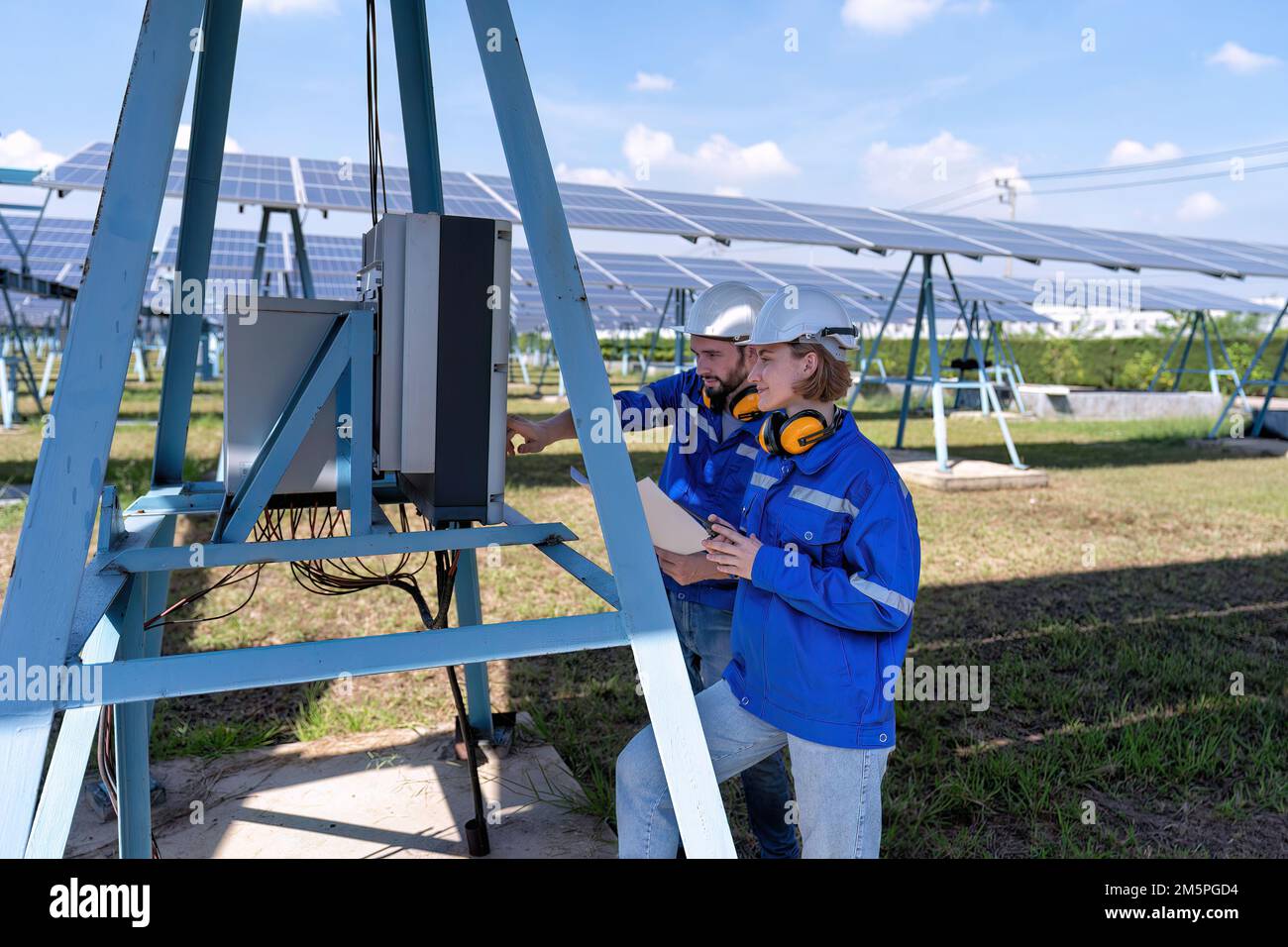 Maintenance engineer at solar farm trouble shooting looking at inverter ...