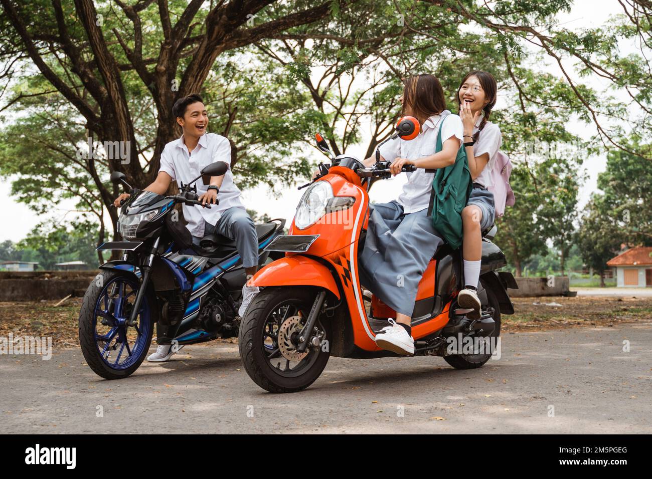 Two naughty high school girls riding motorbikes teasing boy students ... Two naughty high school girls riding motorbikes teasing boy students ...