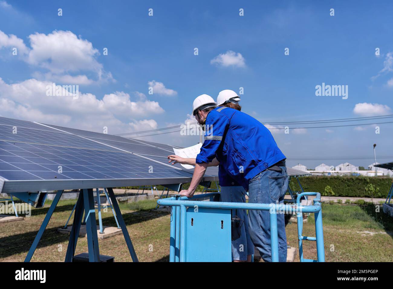Maintenance engineer at solar farm stand on scissor lift routine ...