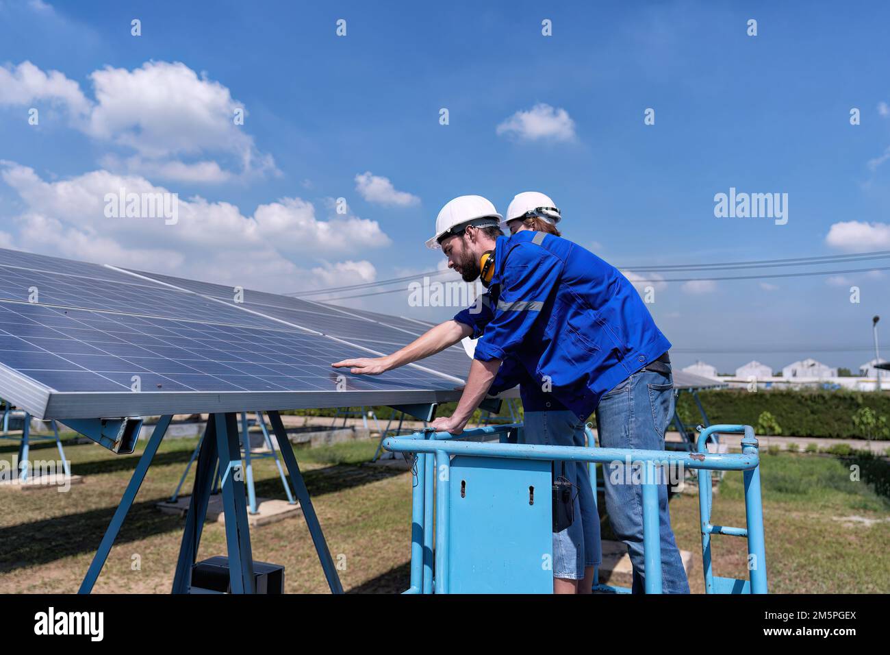 Maintenance engineer at solar farm stand on scissor lift routine ...