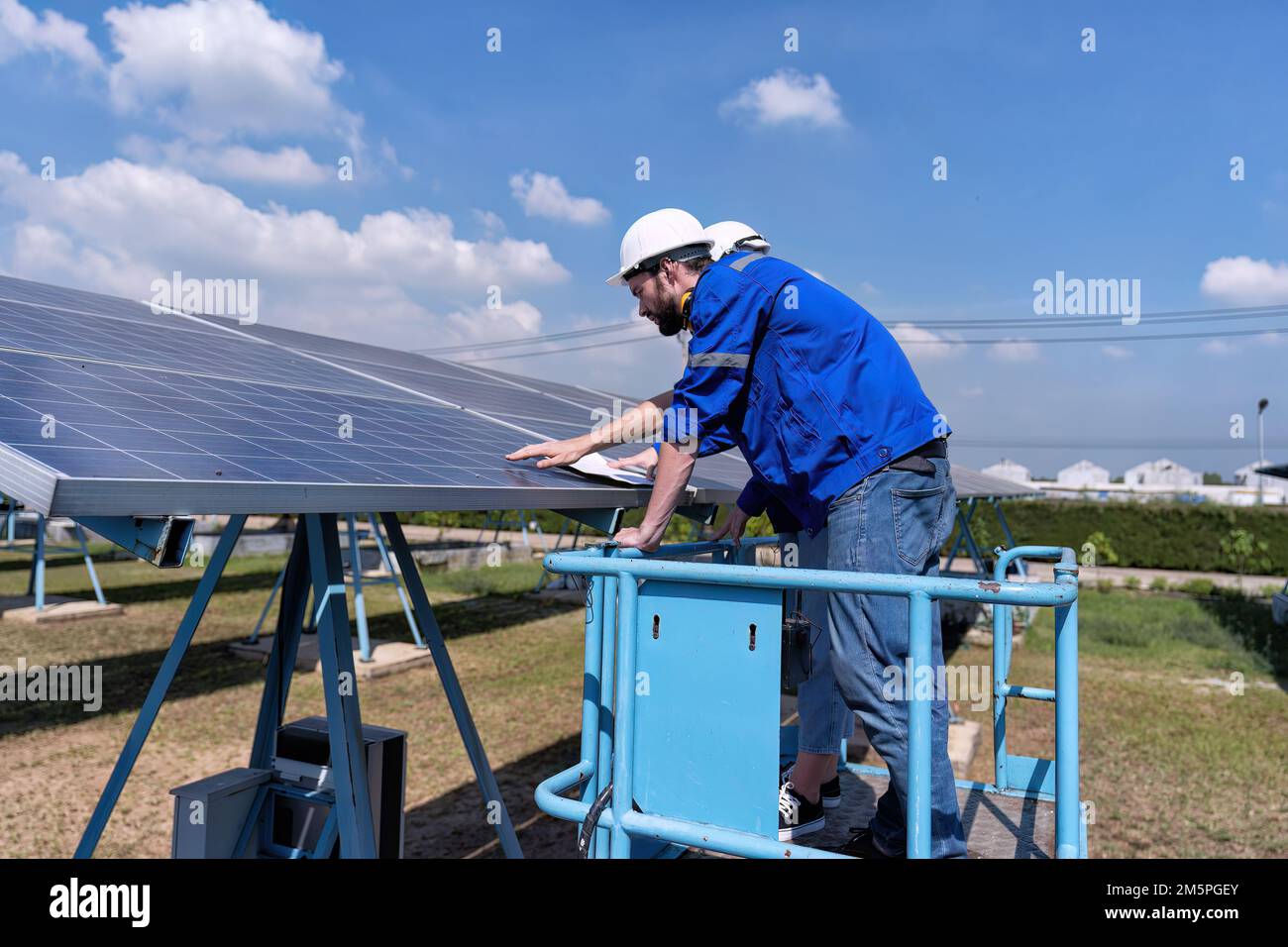 Maintenance engineer at solar farm stand on scissor lift routine ...