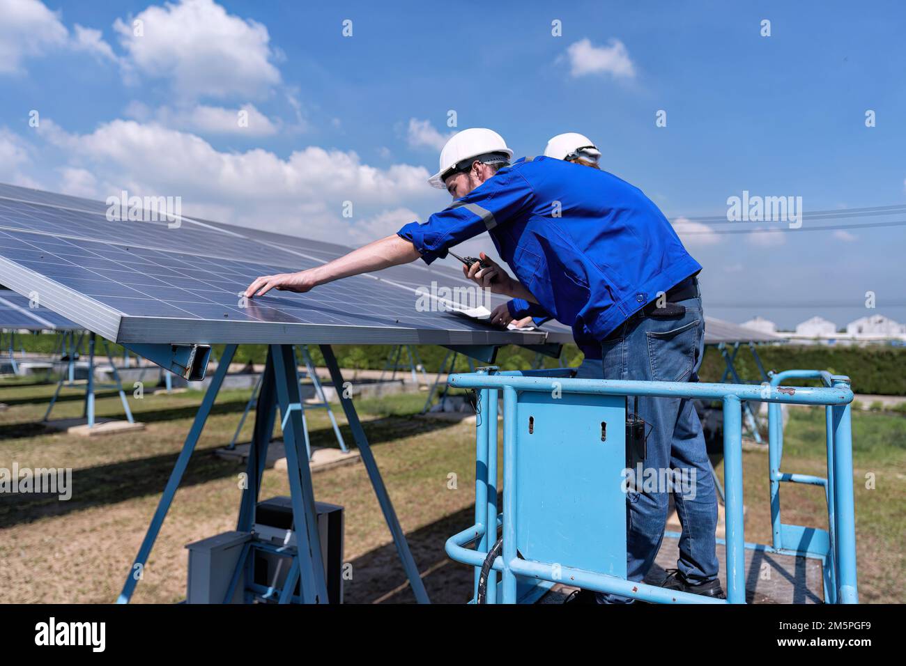 Maintenance engineer at solar farm stand on scissor lift routine ...
