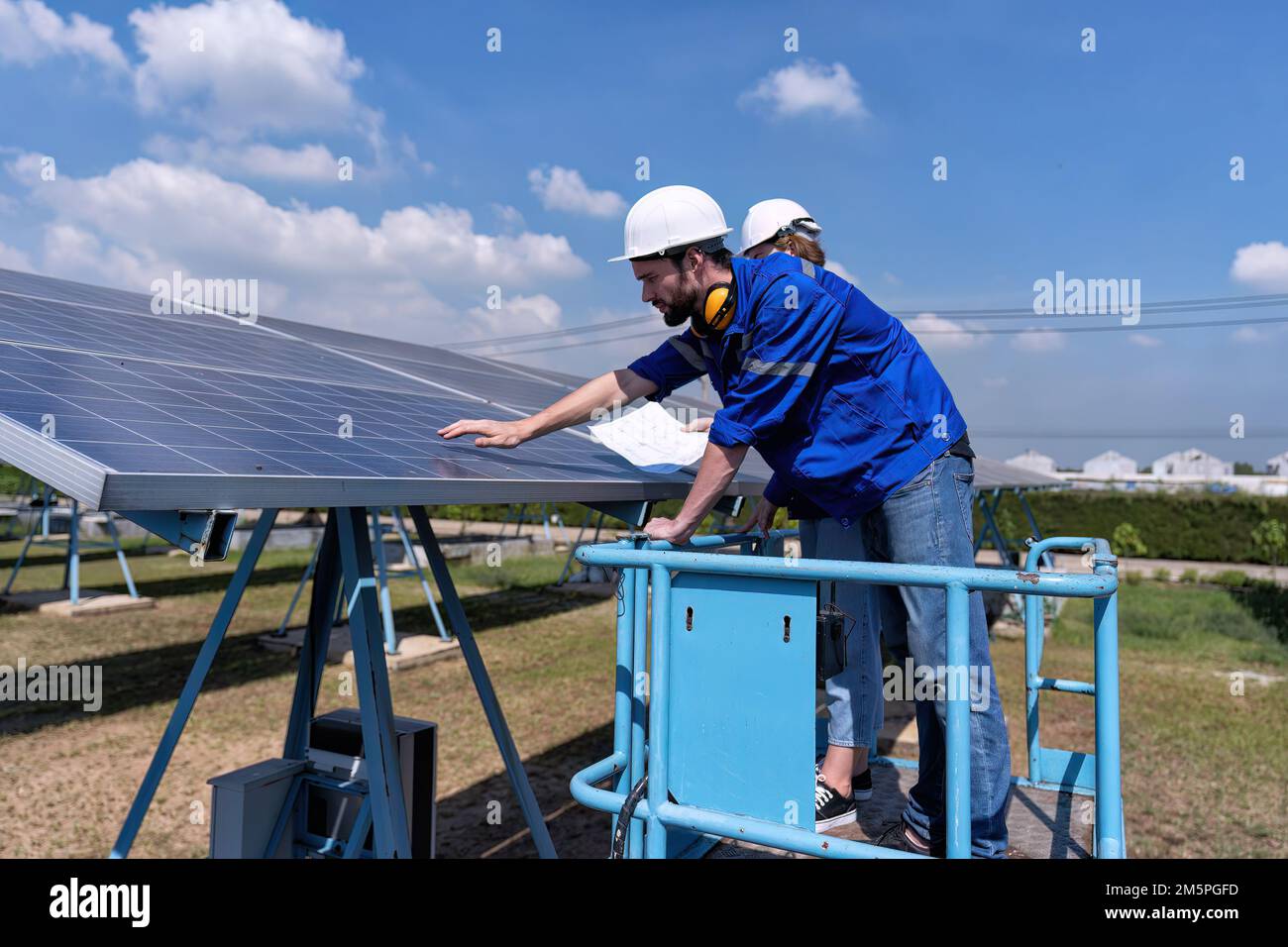 Maintenance engineer at solar farm stand on scissor lift routine ...