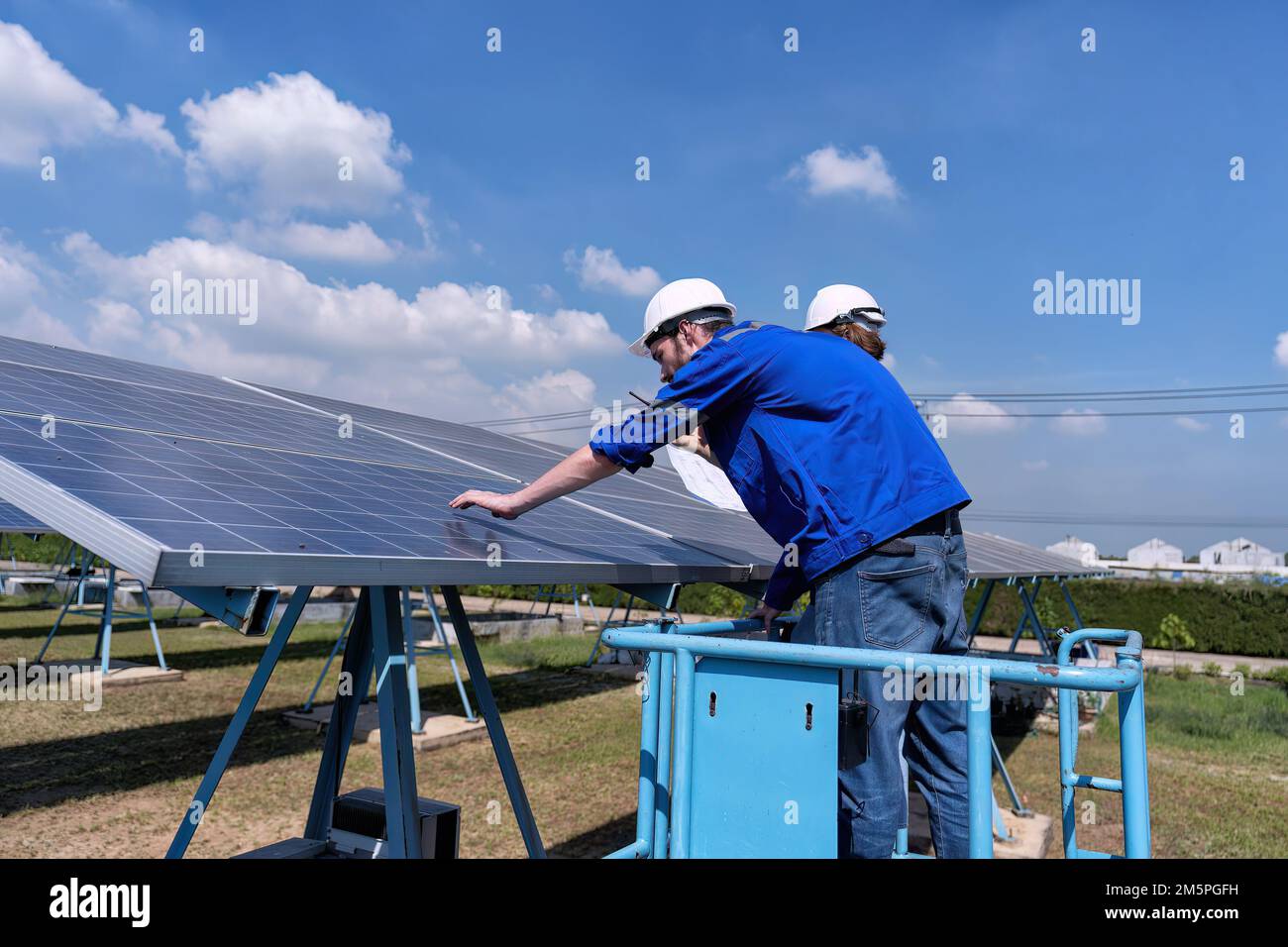 Maintenance engineer at solar farm stand on scissor lift routine ...