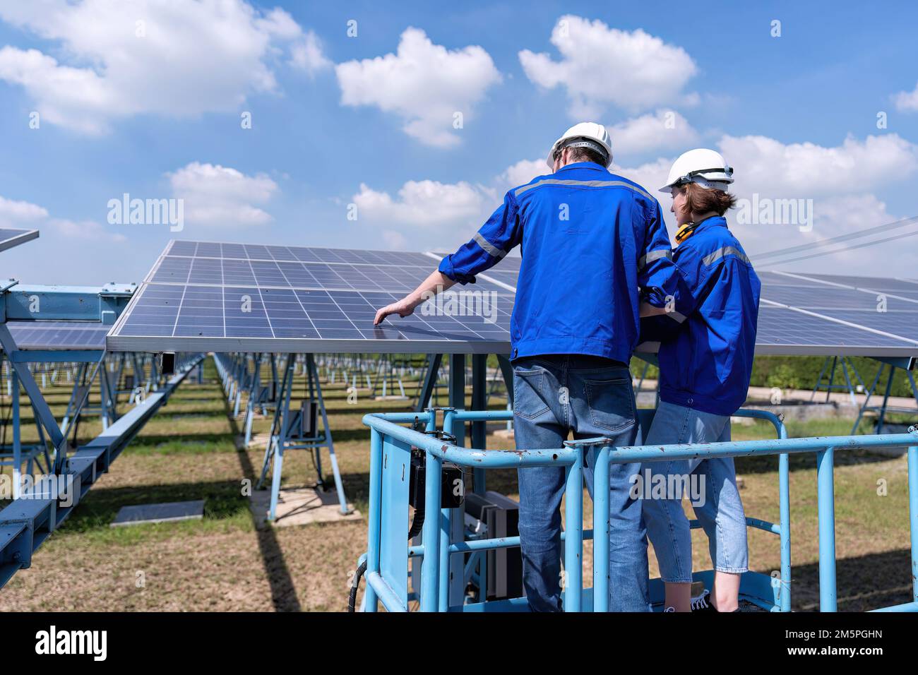 Maintenance engineer at solar farm stand on scissor lift routine ...