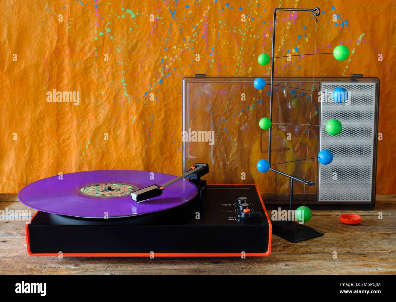 vintage turntable with purple vinyl record, speaker and pop art object ...