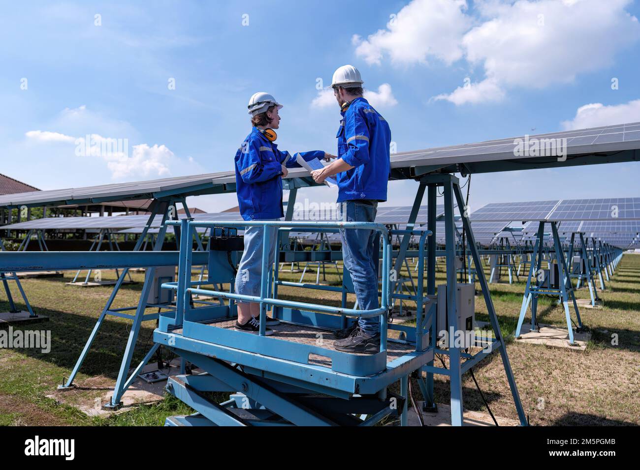 Maintenance engineer at solar farm stand on scissor lift routine ...