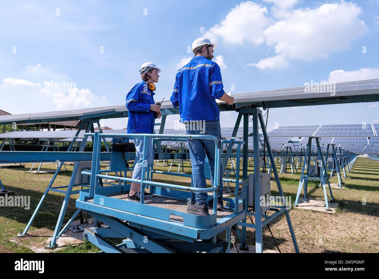 Maintenance engineer at solar farm stand on scissor lift routine ...