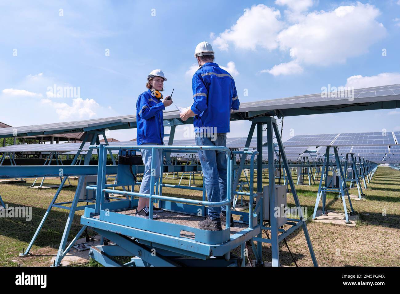 Maintenance engineer at solar farm stand on scissor lift routine ...