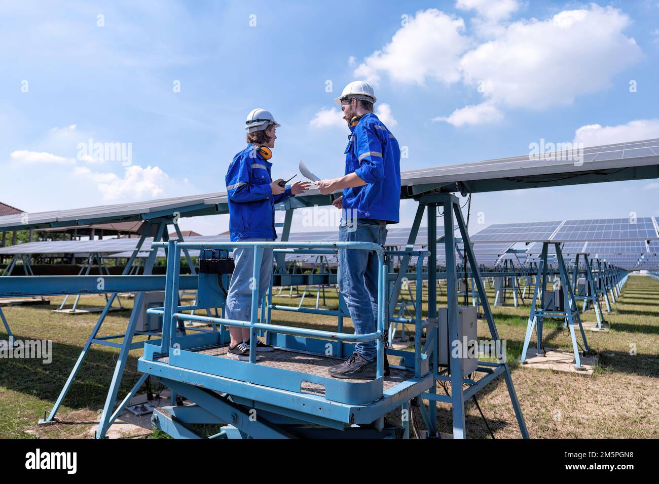 Maintenance engineer at solar farm stand on scissor lift routine ...