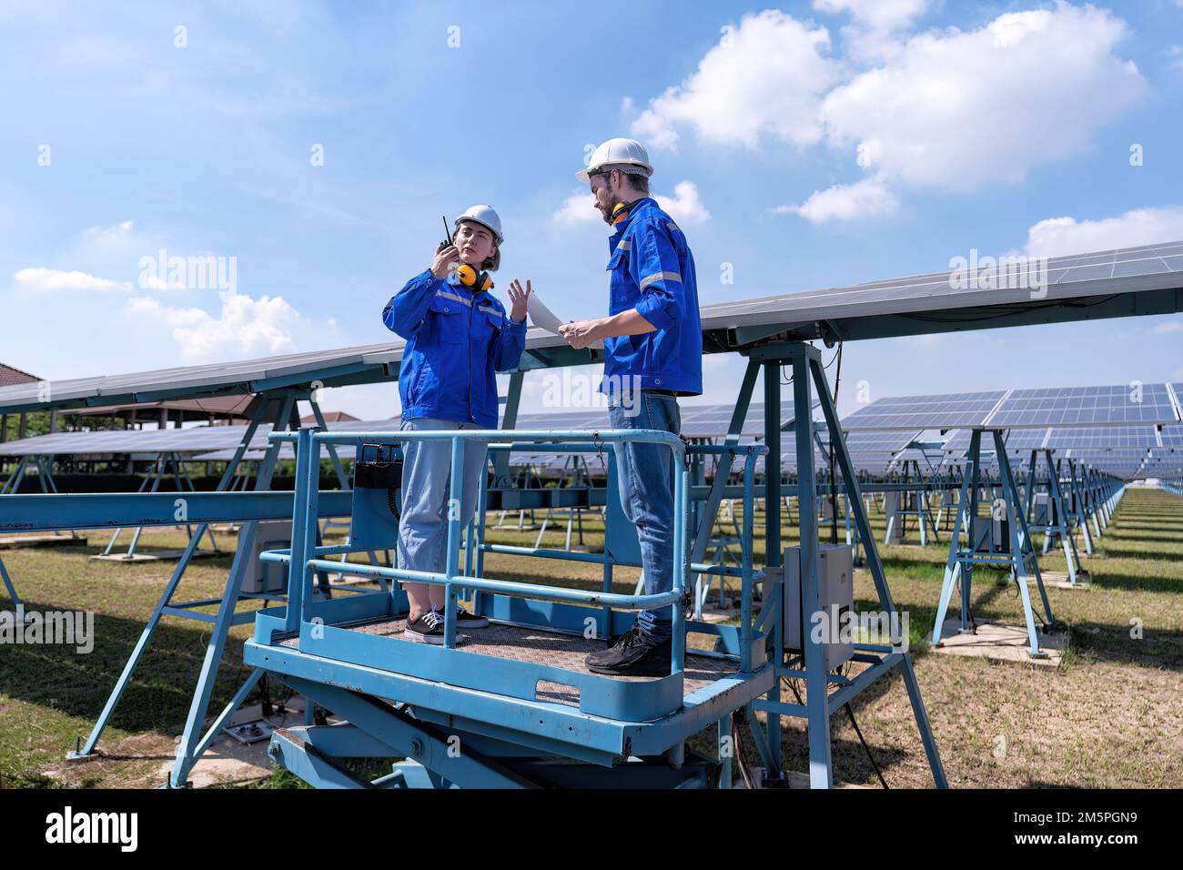 Maintenance engineer at solar farm stand on scissor lift routine ...