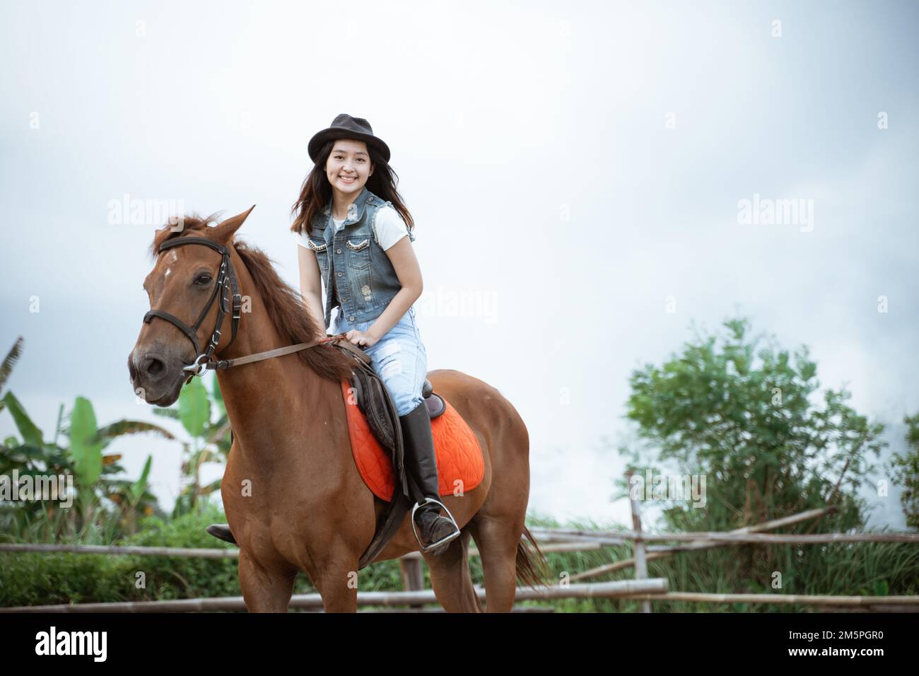 beautiful cowboy girl riding a horse while going Stock Photo - Alamy