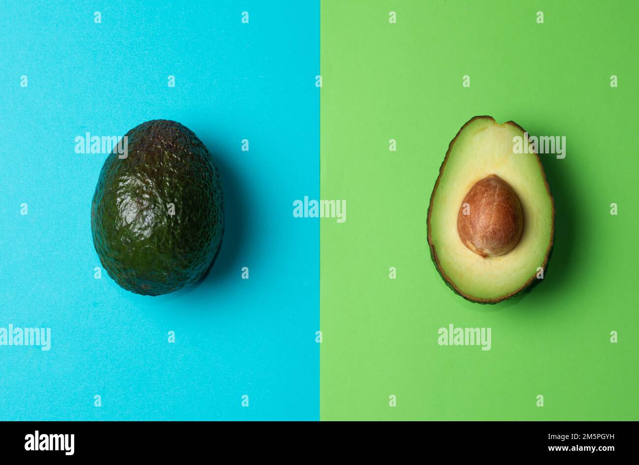Fresh avocados on a blue and green background. Avocado oil in a bottle ...
